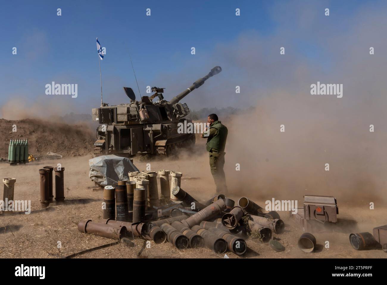 An Israeli mobile artillery unit fires a shell from southern Israel ...