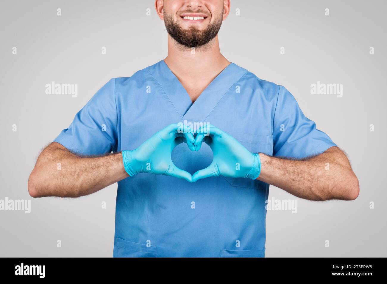 Doctor man wearing gloves and forming heart with hands Stock Photo - Alamy