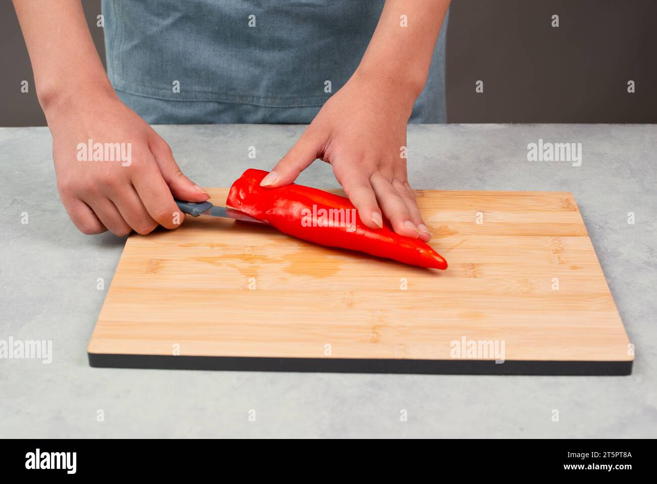 Cutting red pepper on a wooden board, prepare, healthy food with ...