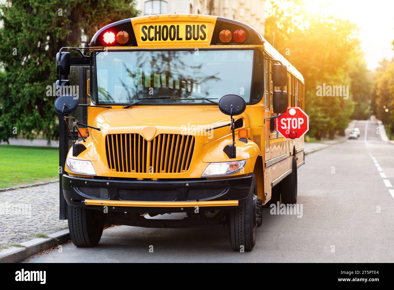 Old-fashioned yellow school bus with red stop sign on the side Stock ...