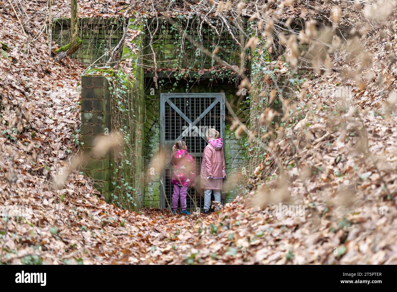 Two little girl friends kids stay at entrance of old abandoned entrance ...