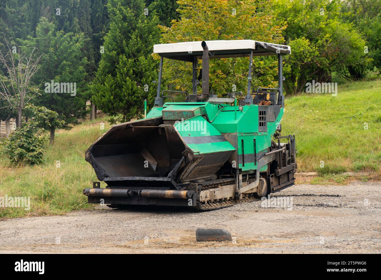 Asphalt paver machine. Asphalt finisher or paving machine placing a ...