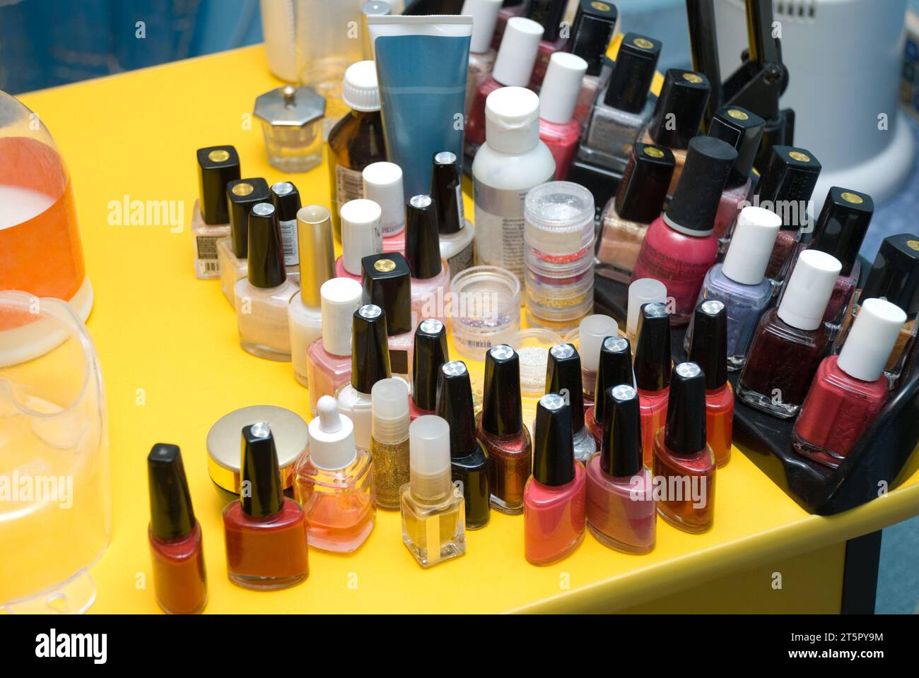Manicure table with different color enamel bottles Stock Photo - Alamy