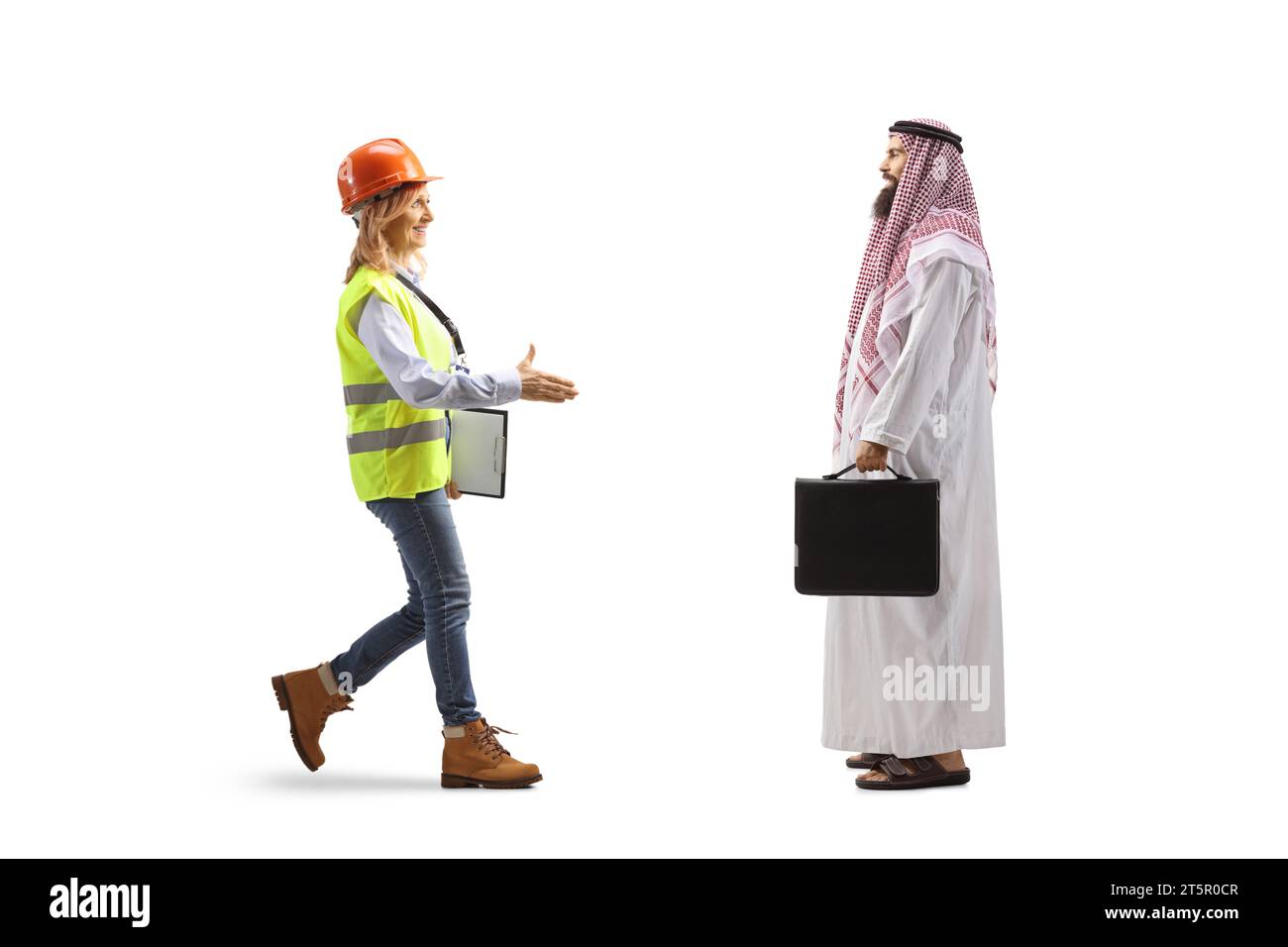 Full length profile shot of a female engineer walking and meeting a ...