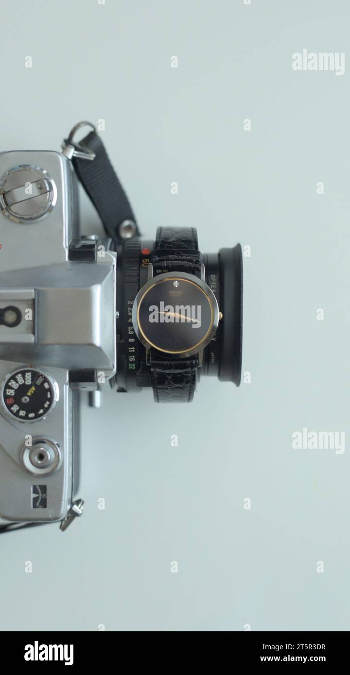 Seiko watch wraps around the lens of a camera Stock Photo - Alamy