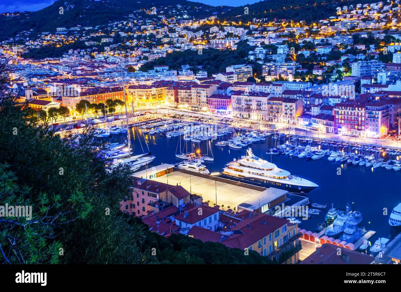 Awe Nice (French Riviera) in blue hour and illuminated port Lympia with motor yachts and ...