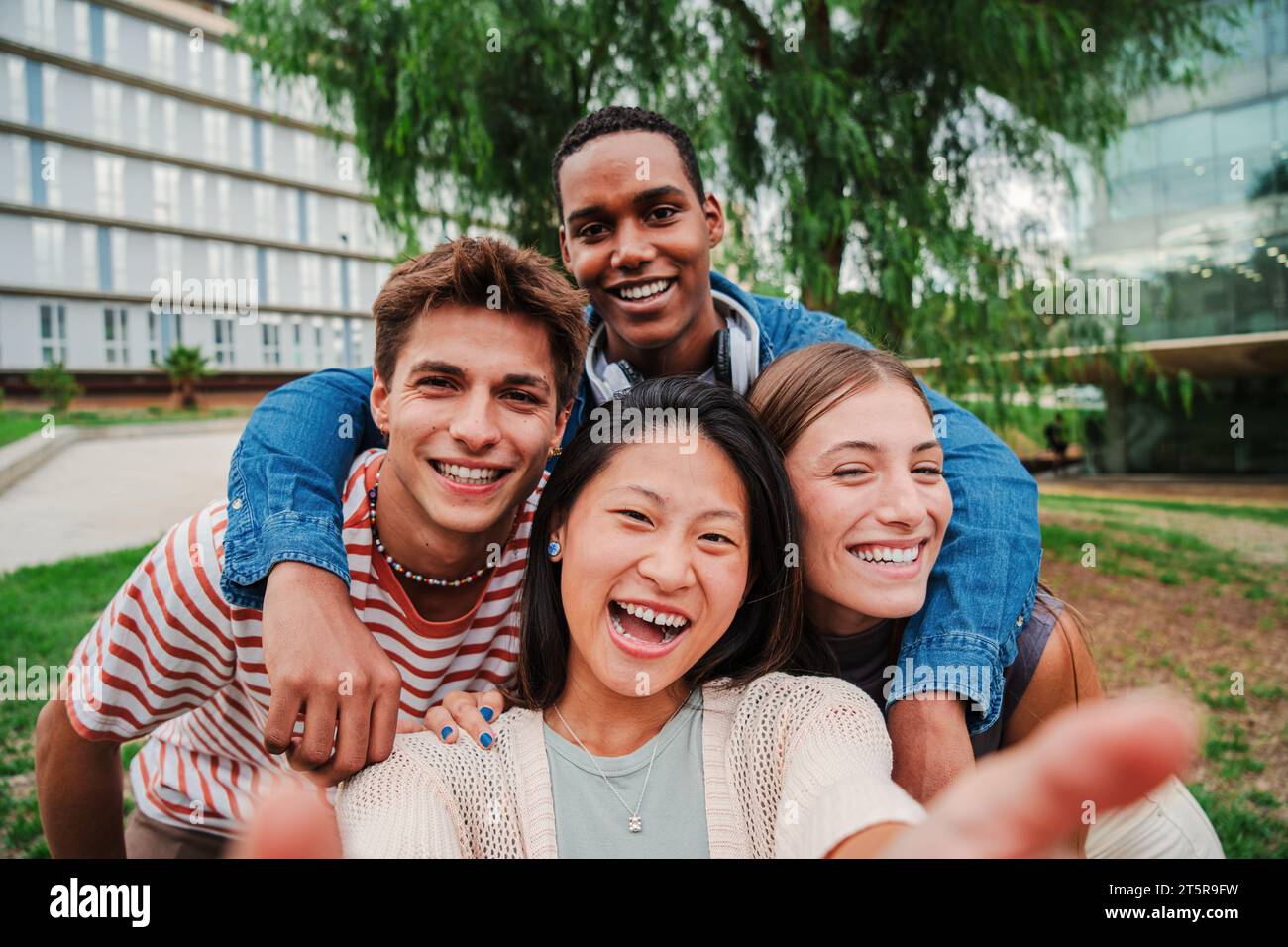 Group of young multiracial high school students taking a selfie ...
