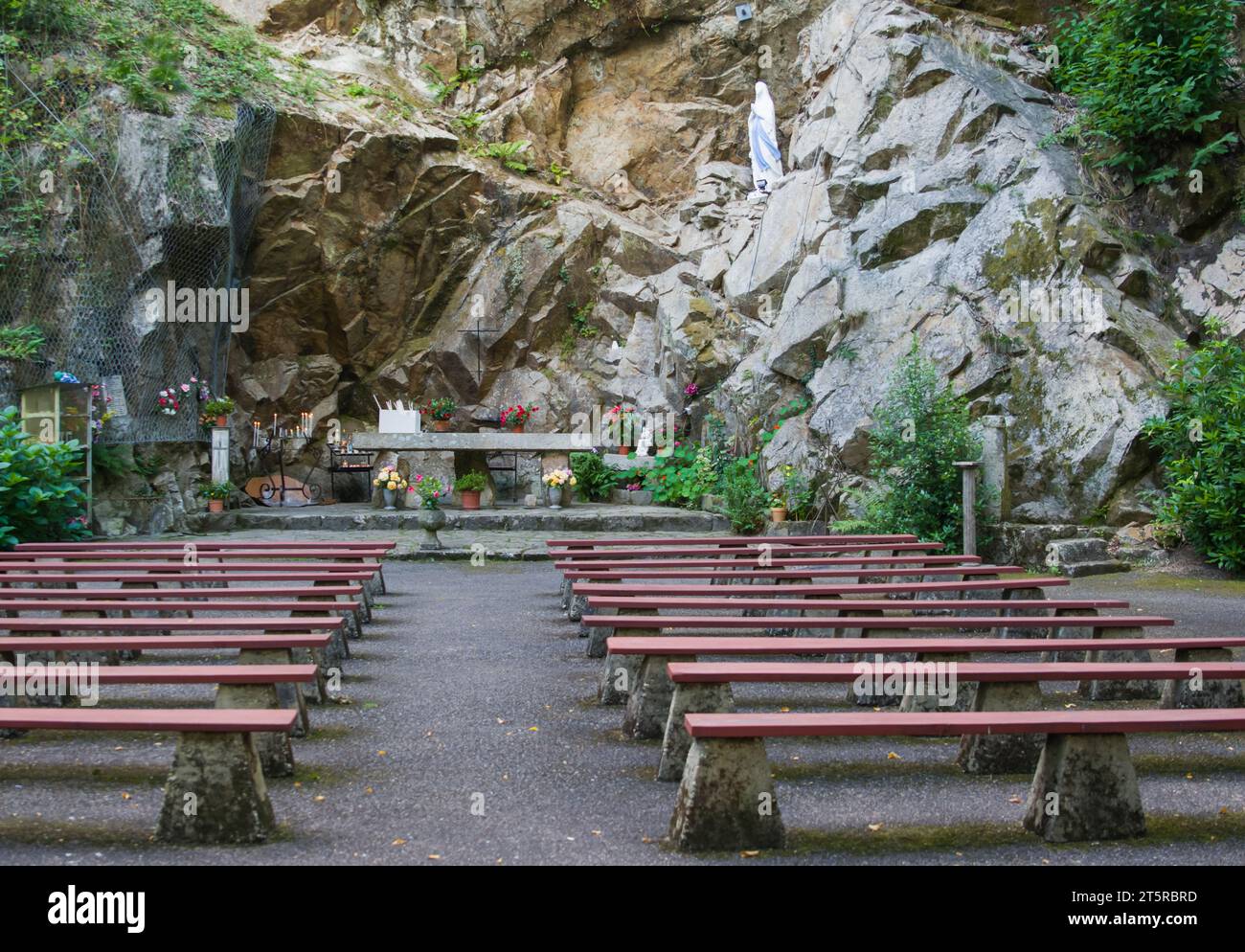 Cave grotto with the benches for prayer under open-air Stock Photo - Alamy