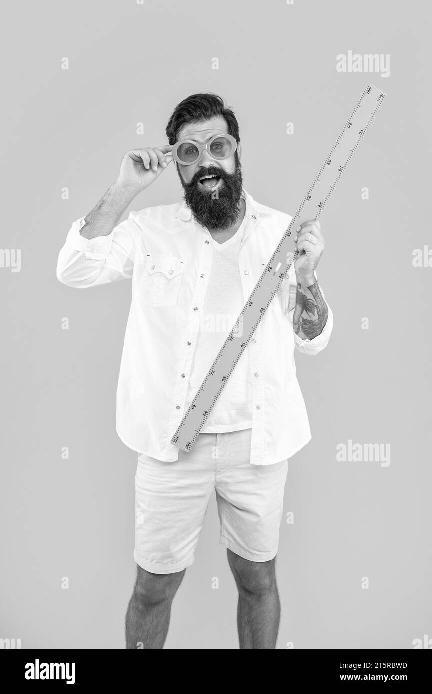 photo of amazed school man measure with ruler. school man measure with ...