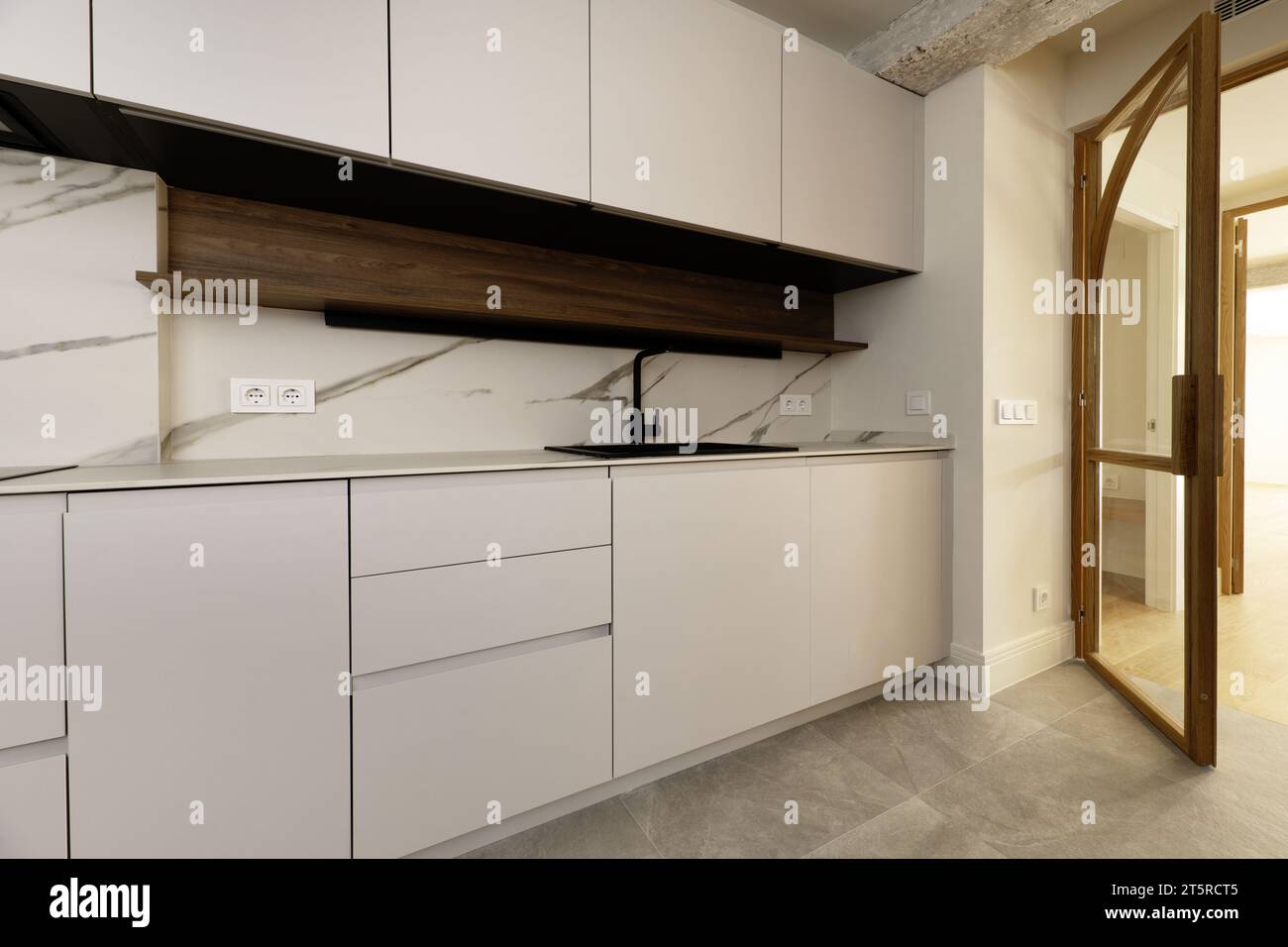 Newly installed kitchen with white handleless cabinets Stock Photo - Alamy