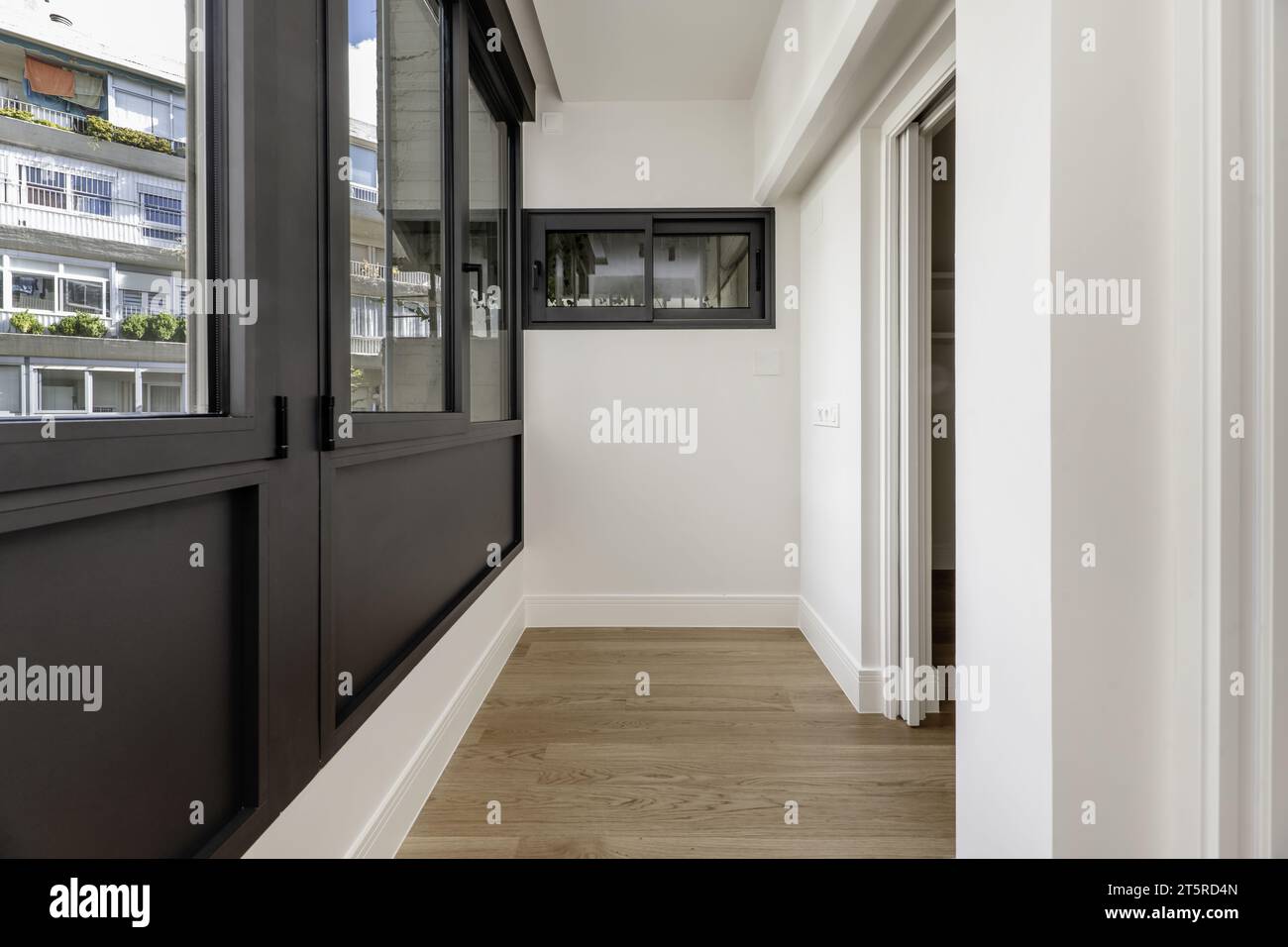 A closed terrace with glazing and a black metal structure Stock Photo ...