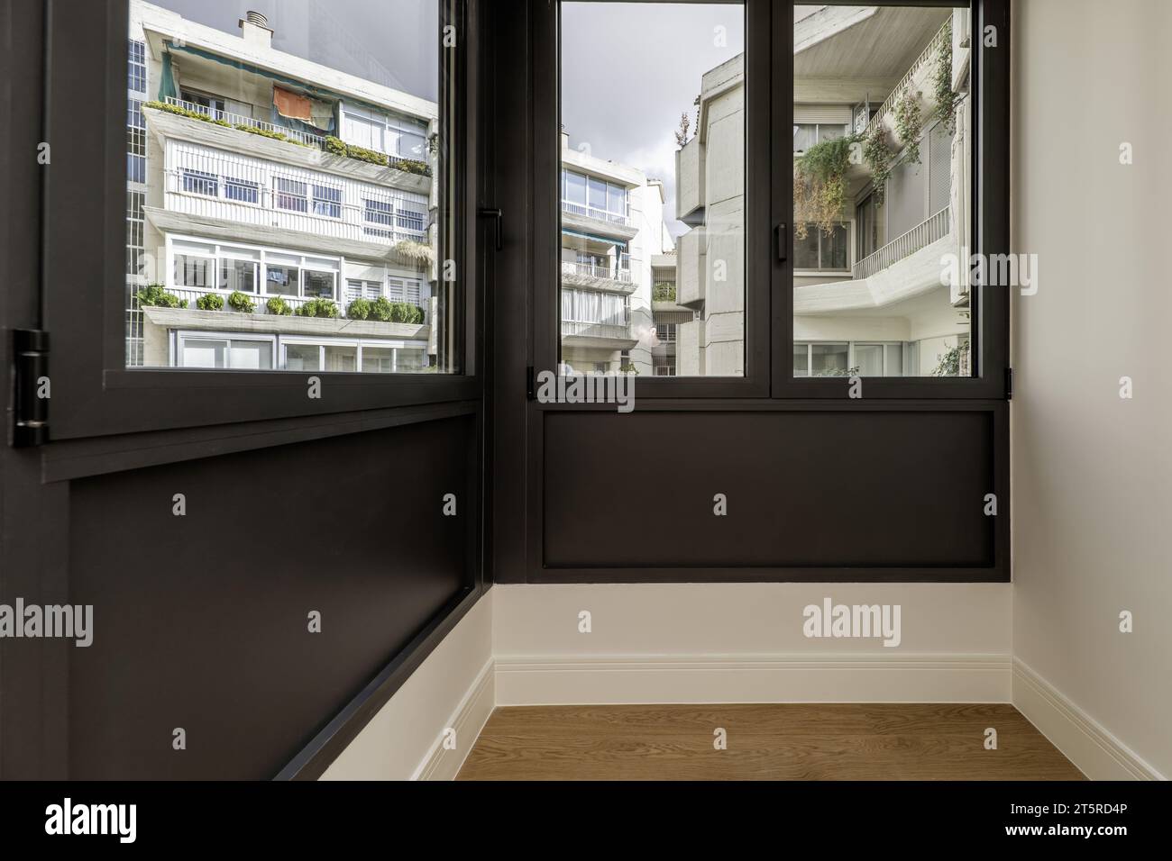 Small closed terrace with glazing and black metal Stock Photo - Alamy