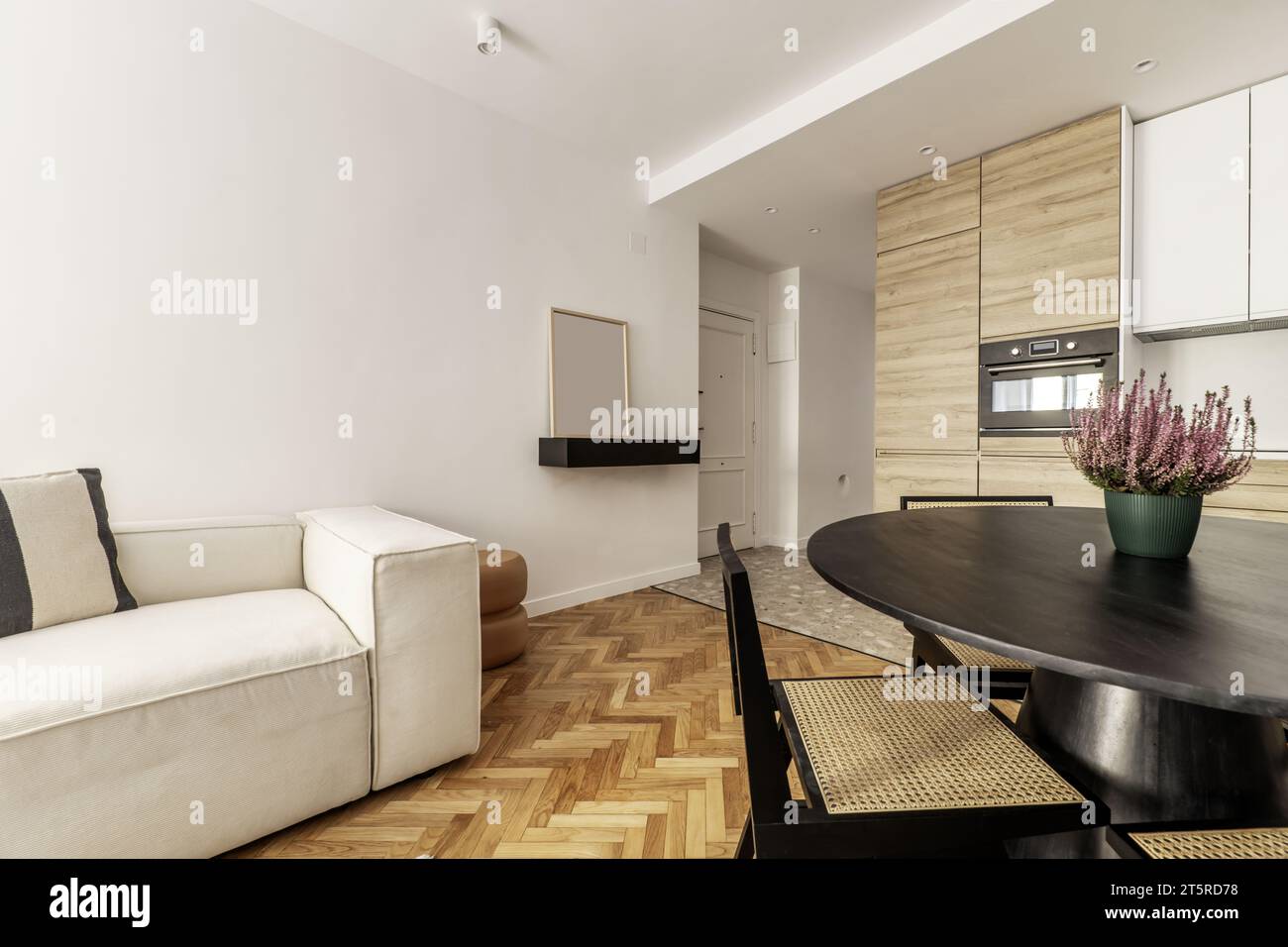 Living room of a modern house with circular black wooden table, chairs ...
