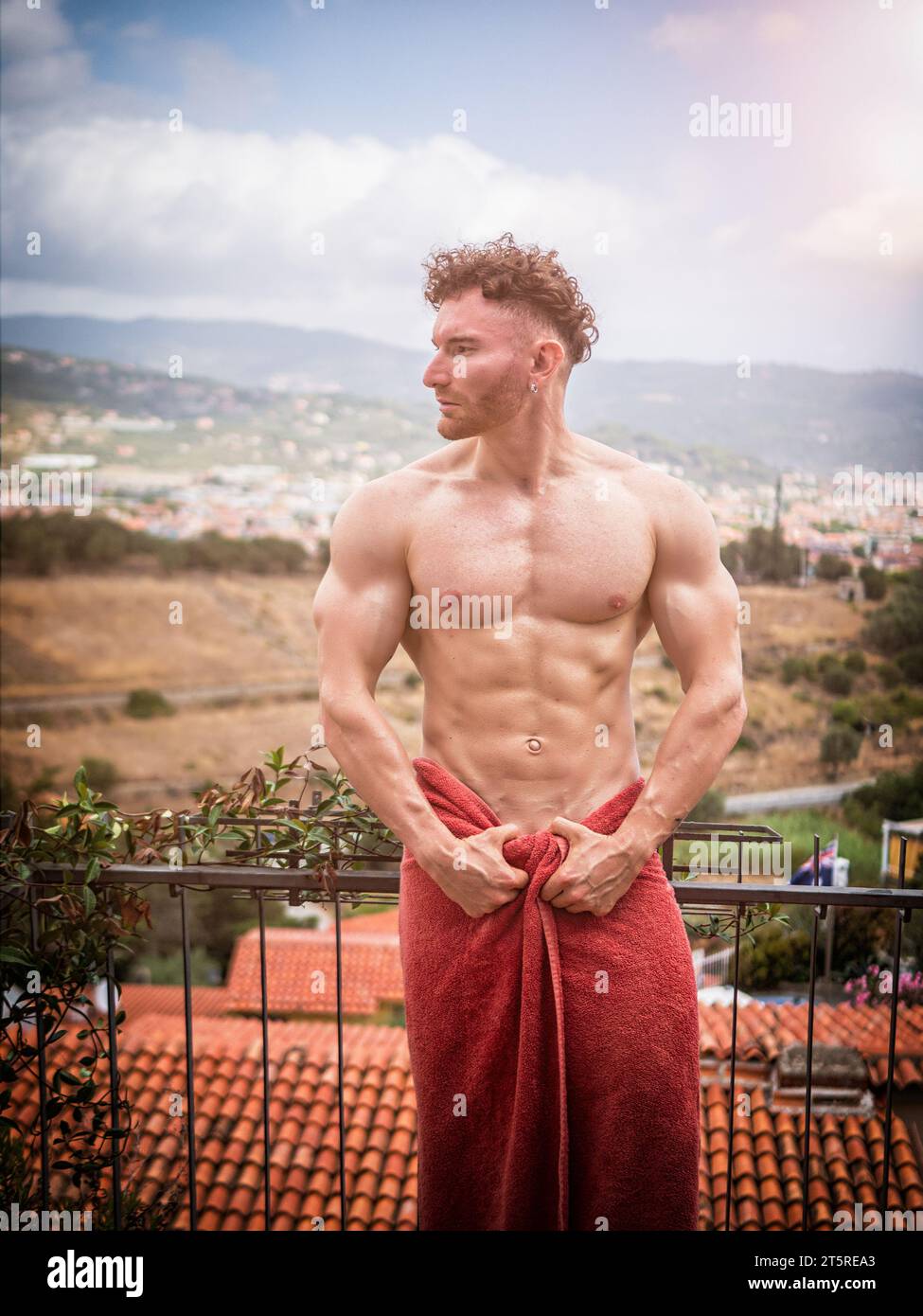 A red haired muscular man with a towel wrapped around his waist on balcony Stock Photo - Alamy