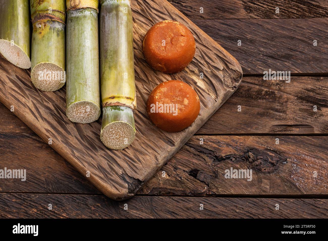 Sweet panela with sugar cane stalks - Saccharum officinarum Stock Photo ...