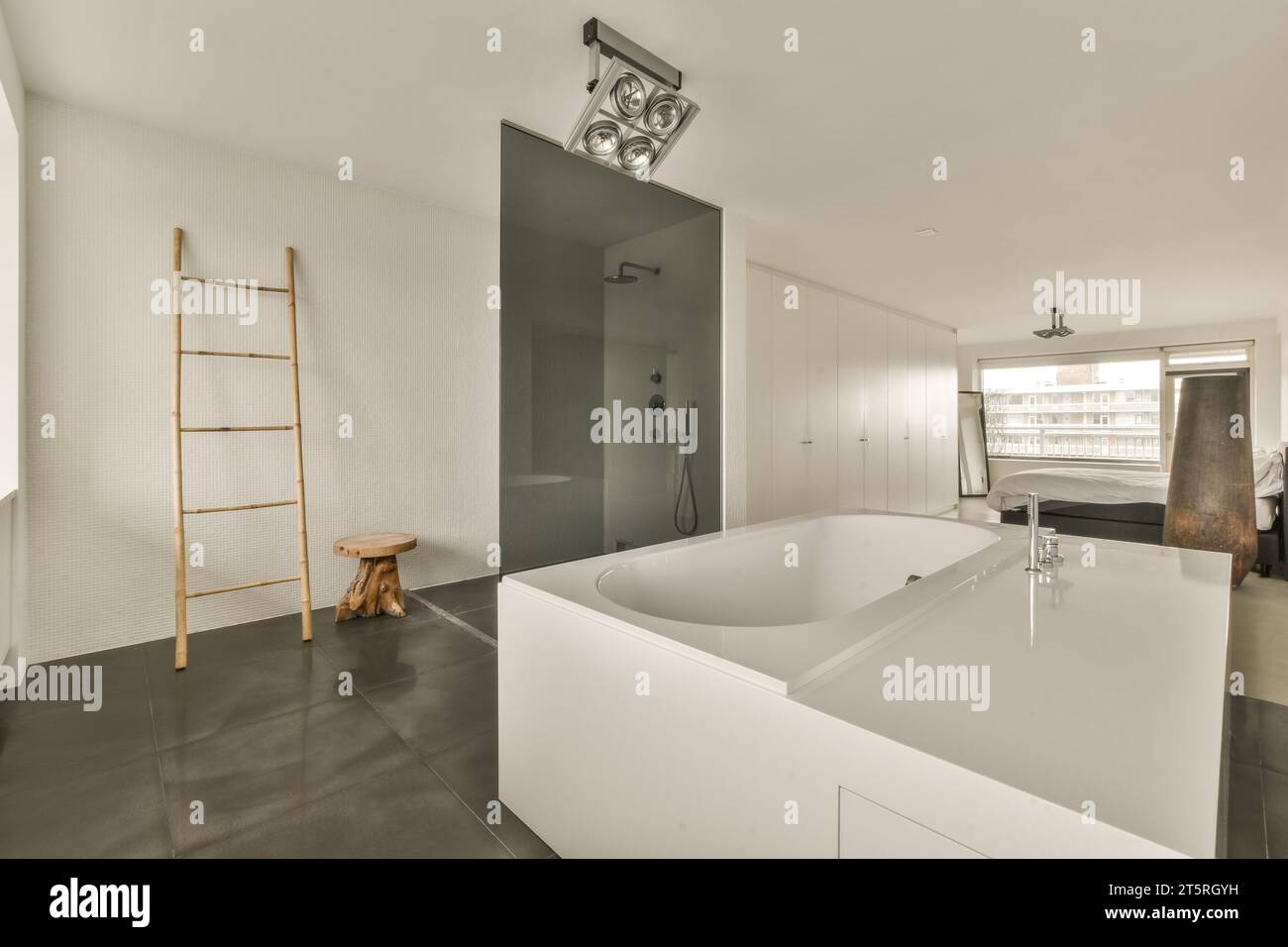 a modern bathroom with white walls and black tiles on the floor, along ...