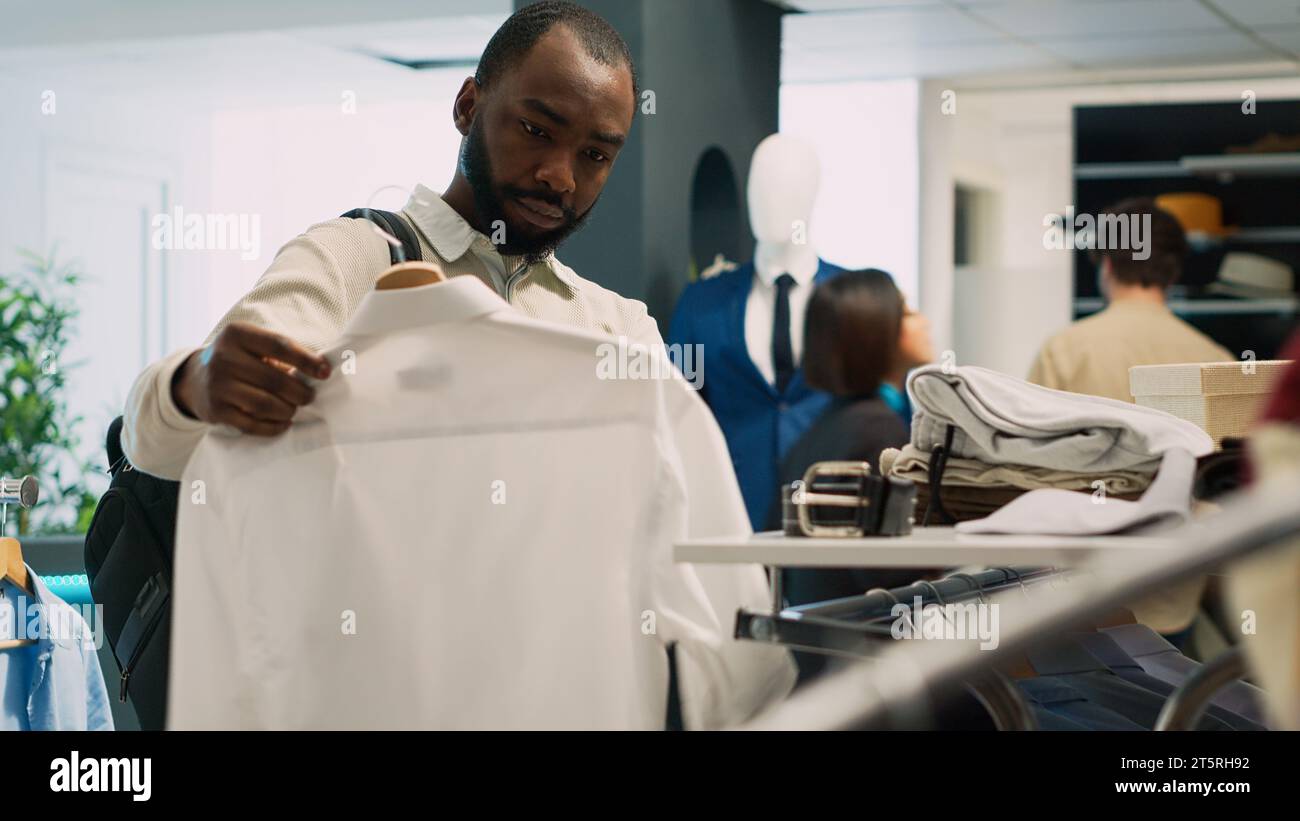 African american client analyzing clothes and accessories in clothing ...