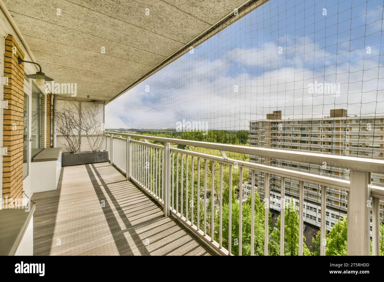 a balcony with some buildings in the background and blue skies overhead ...