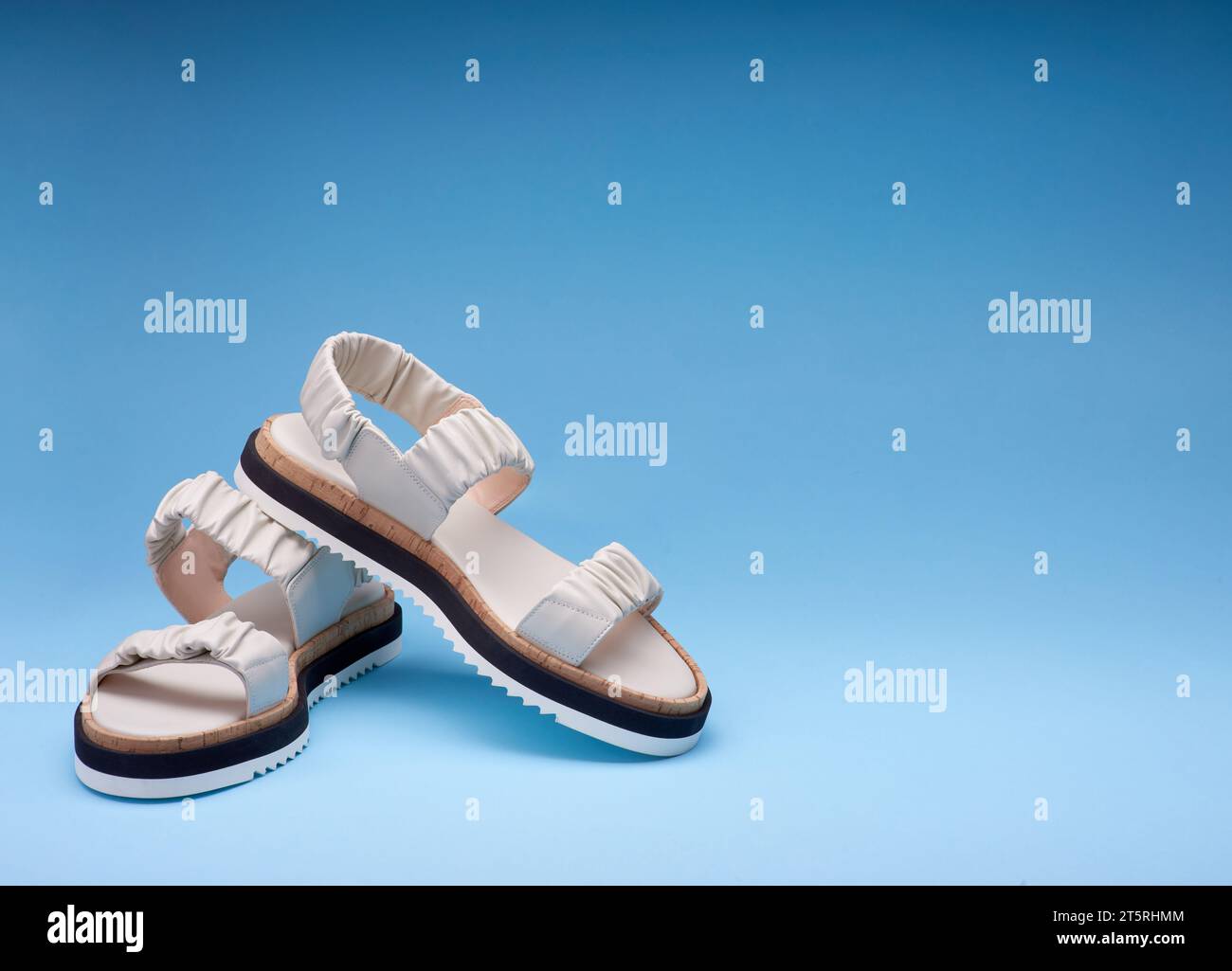 A shot of new pastel leather sandals with three-colored soles placed ...