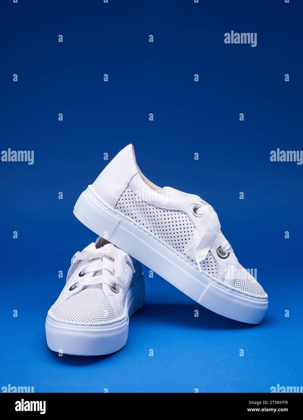 Trendy white sneakers from perforated leather with thick stitched ...