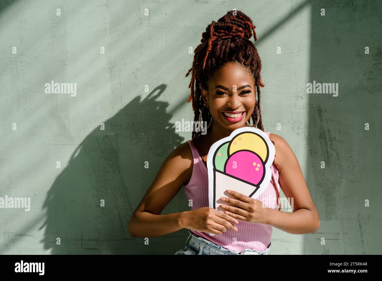 Outdoors portrait of a joyful smilling young black woman with ...