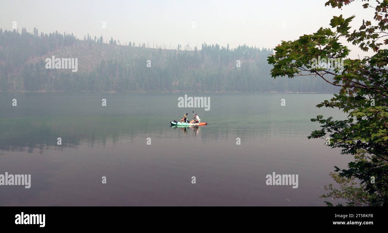 Father and daughter kayakers on Suttle Lake in the Cascade mountains of ...
