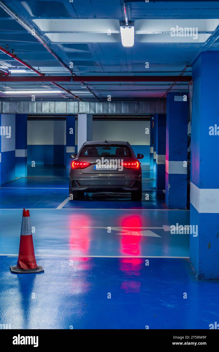 Scene in a underground car park showing the rear of a car with its ...
