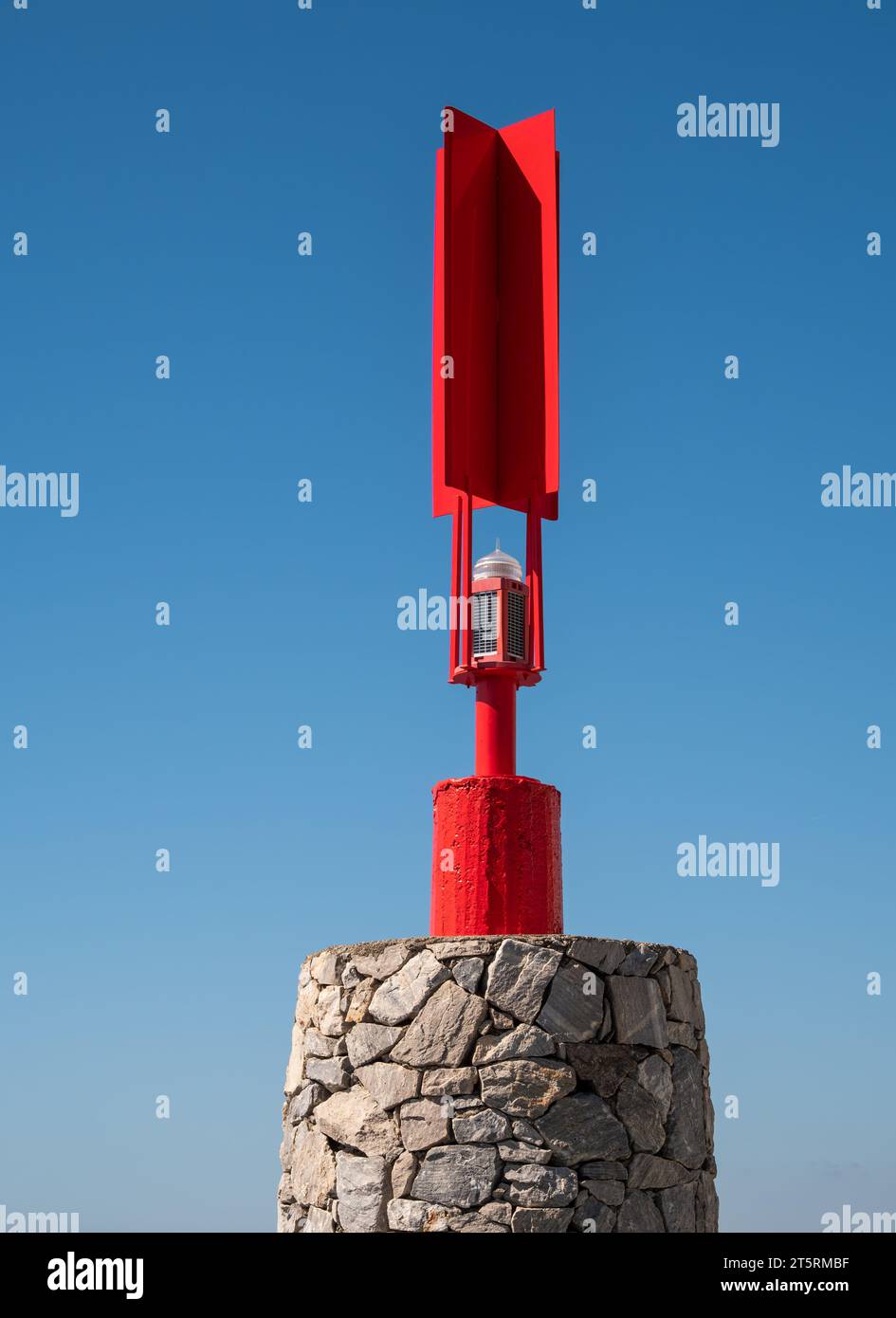 A red beacon/navigation aid set on a stone pillar at Puerto Banus ...