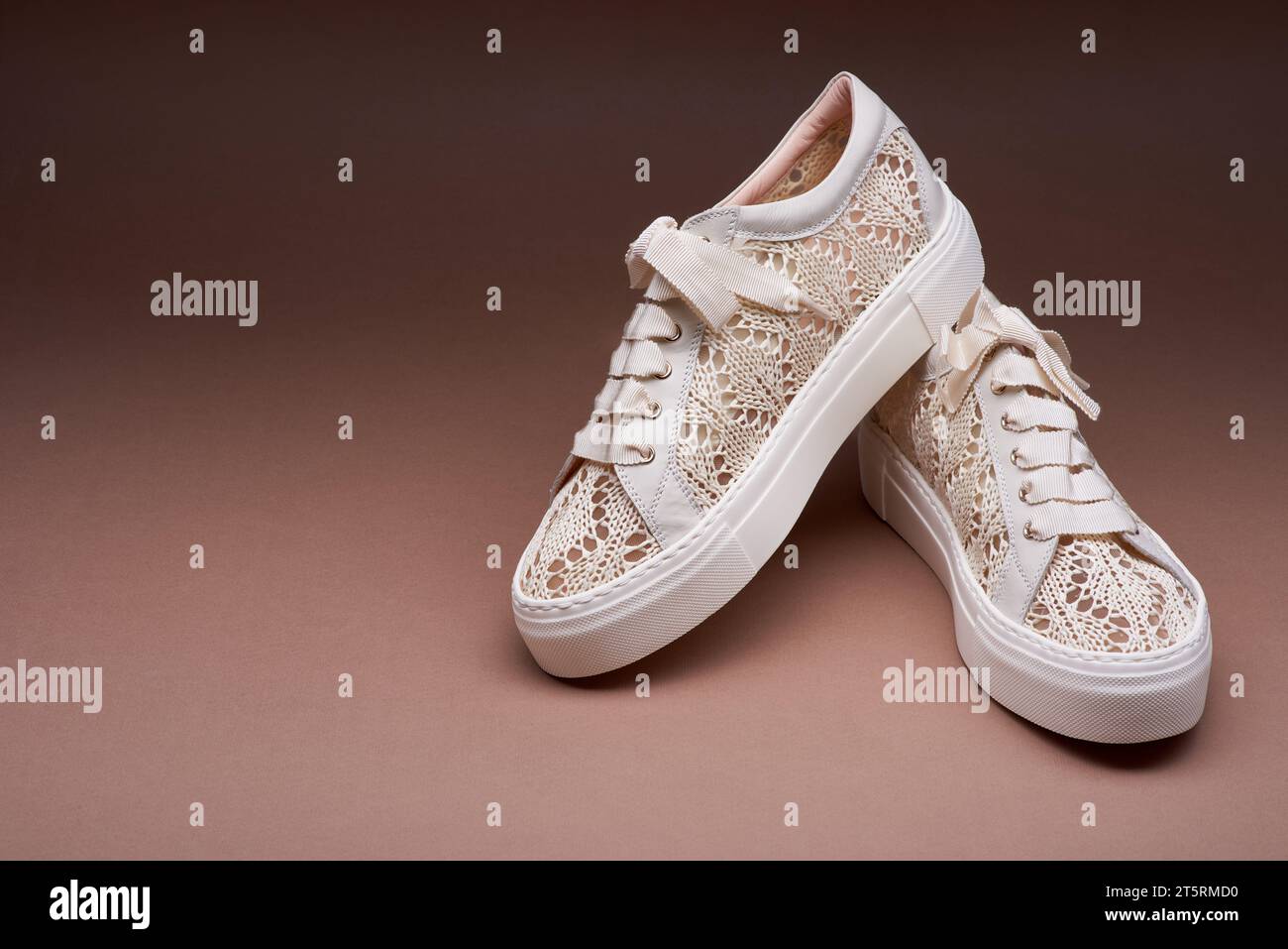 Stylish pastel knitted design sneakers with white thick rubber soles on ...