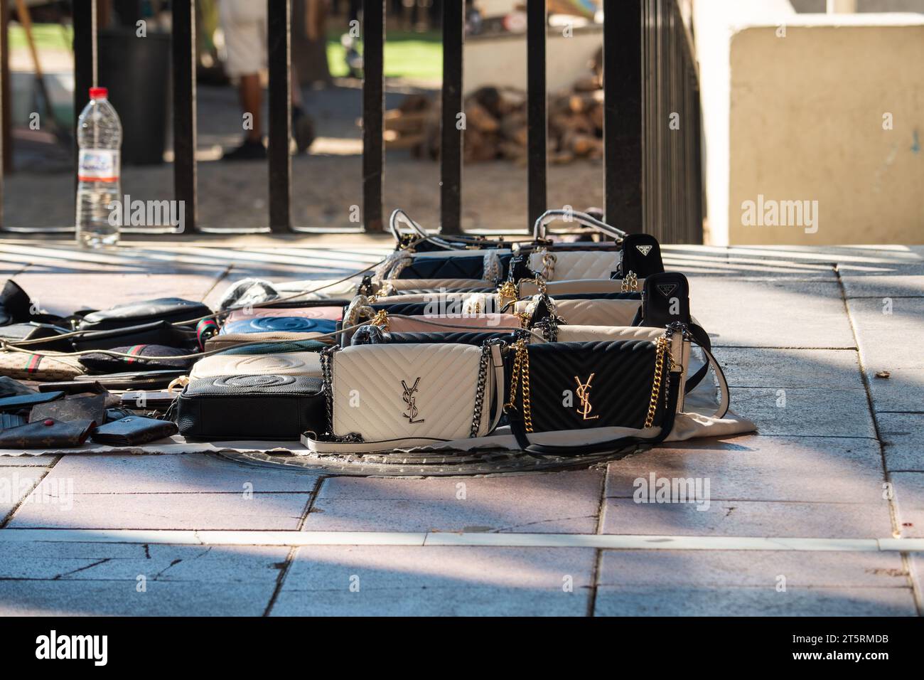 Fake designer handbags on a pavement/sidewalk sold by street vendors ...