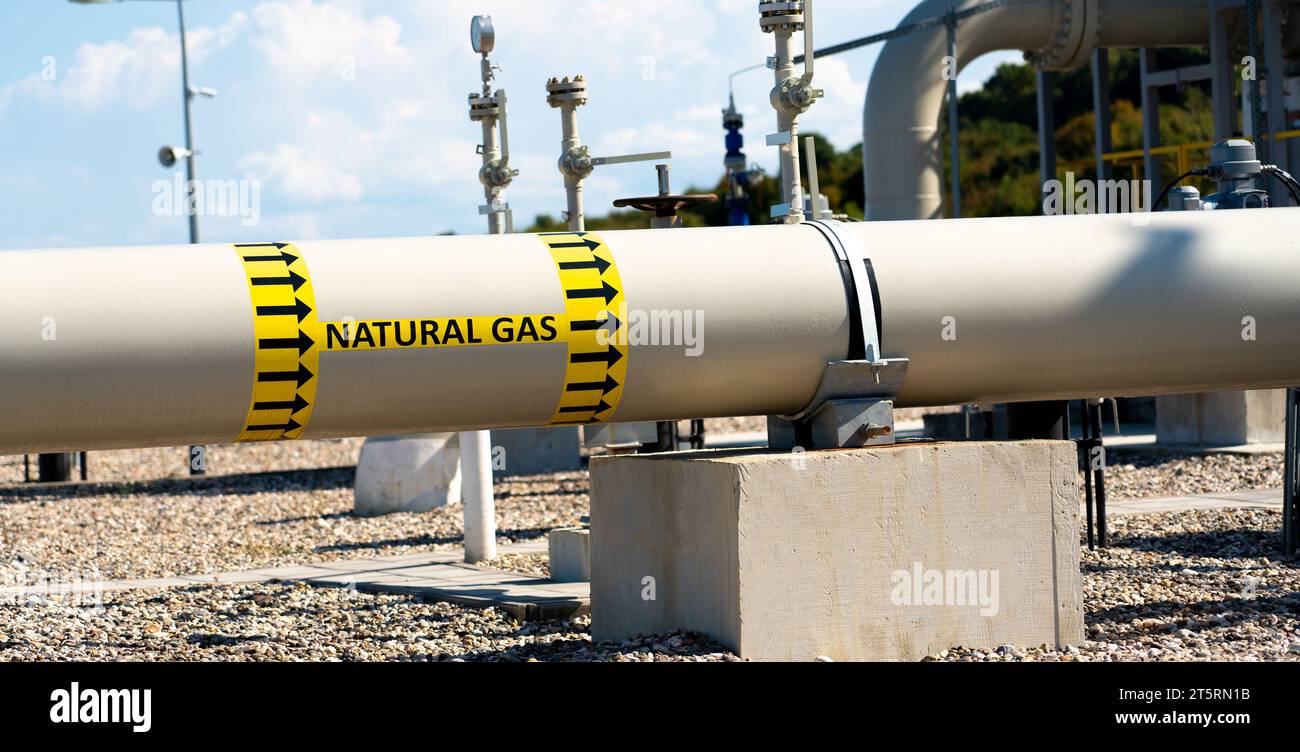 Metal gas pipeline pipe with background of various equipment and ...