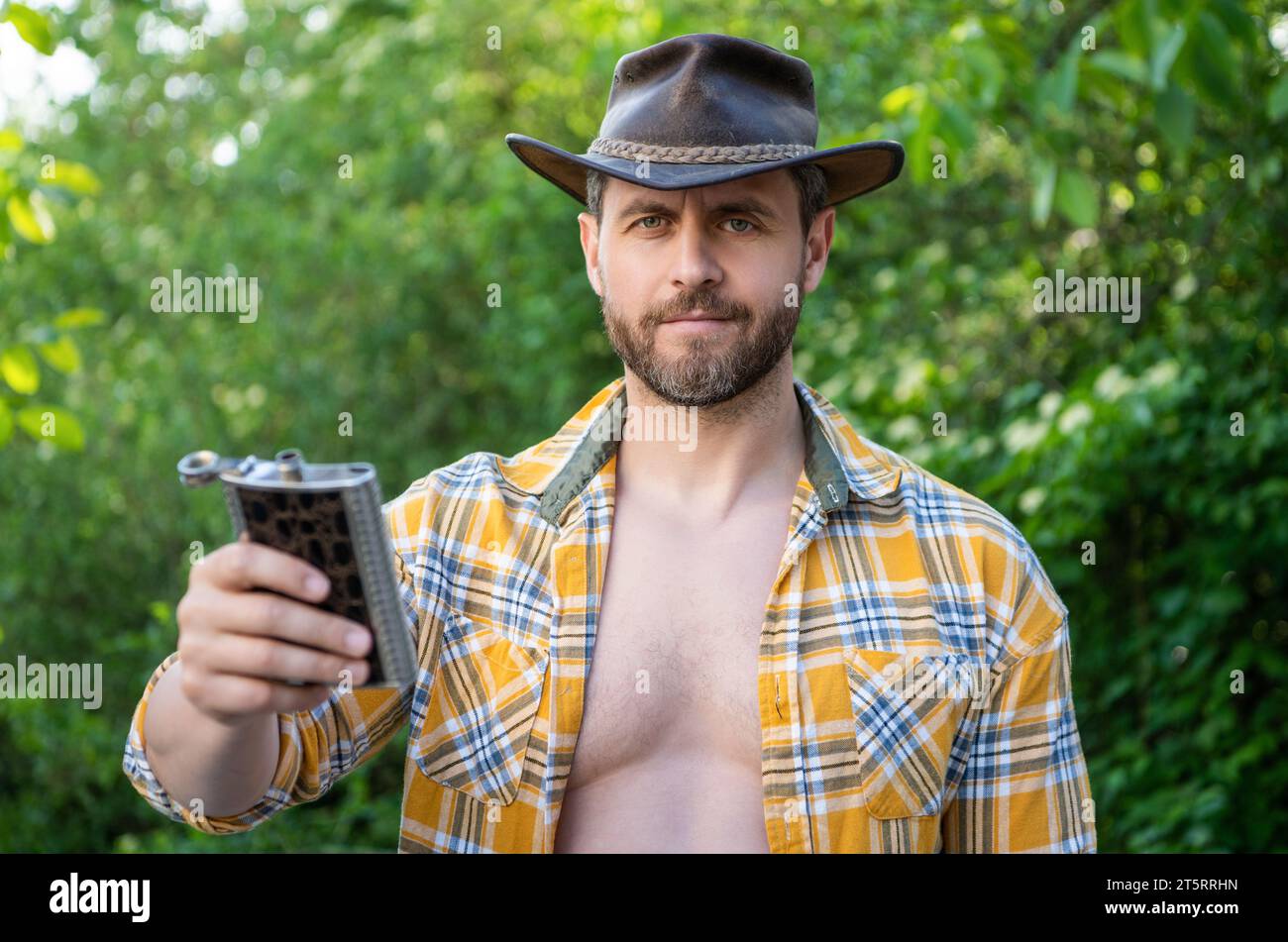 man offer bourbon hipflask wear checkered shirt. photo of cowboy man ...