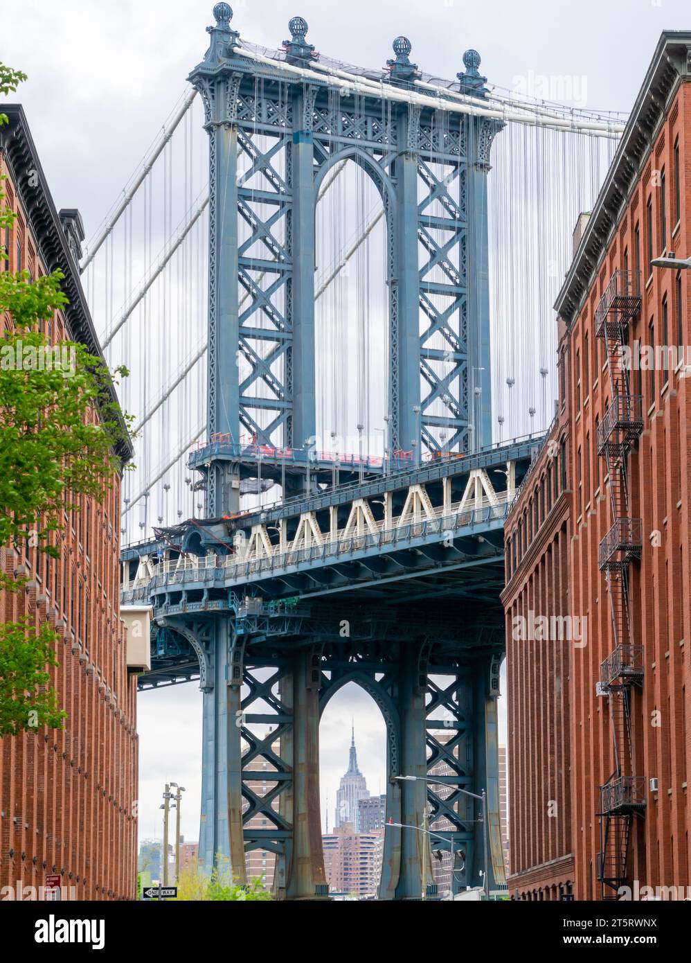 View of the famous Manhattan Bridge, with the Empire State Building in ...