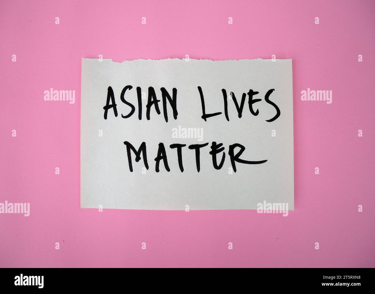 Paper with English words 'STOP ASIAN HATE' with pink heart in gray ...