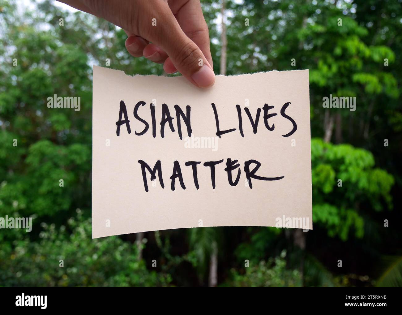 Paper with English words 'STOP ASIAN HATE' with pink heart in gray ...