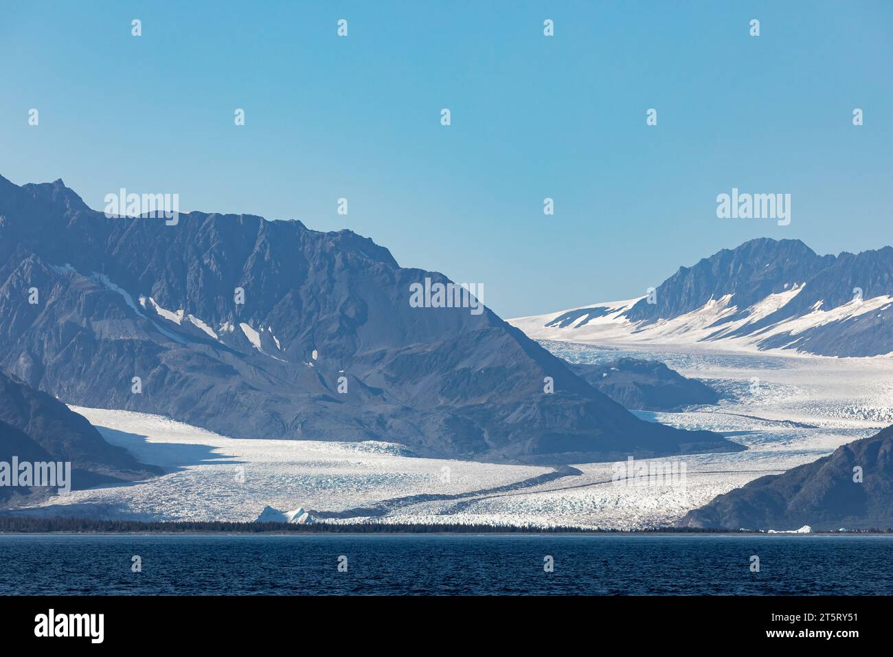 Blue ice of the Aialik Glacier meets the ocean waters of the Gulf of ...
