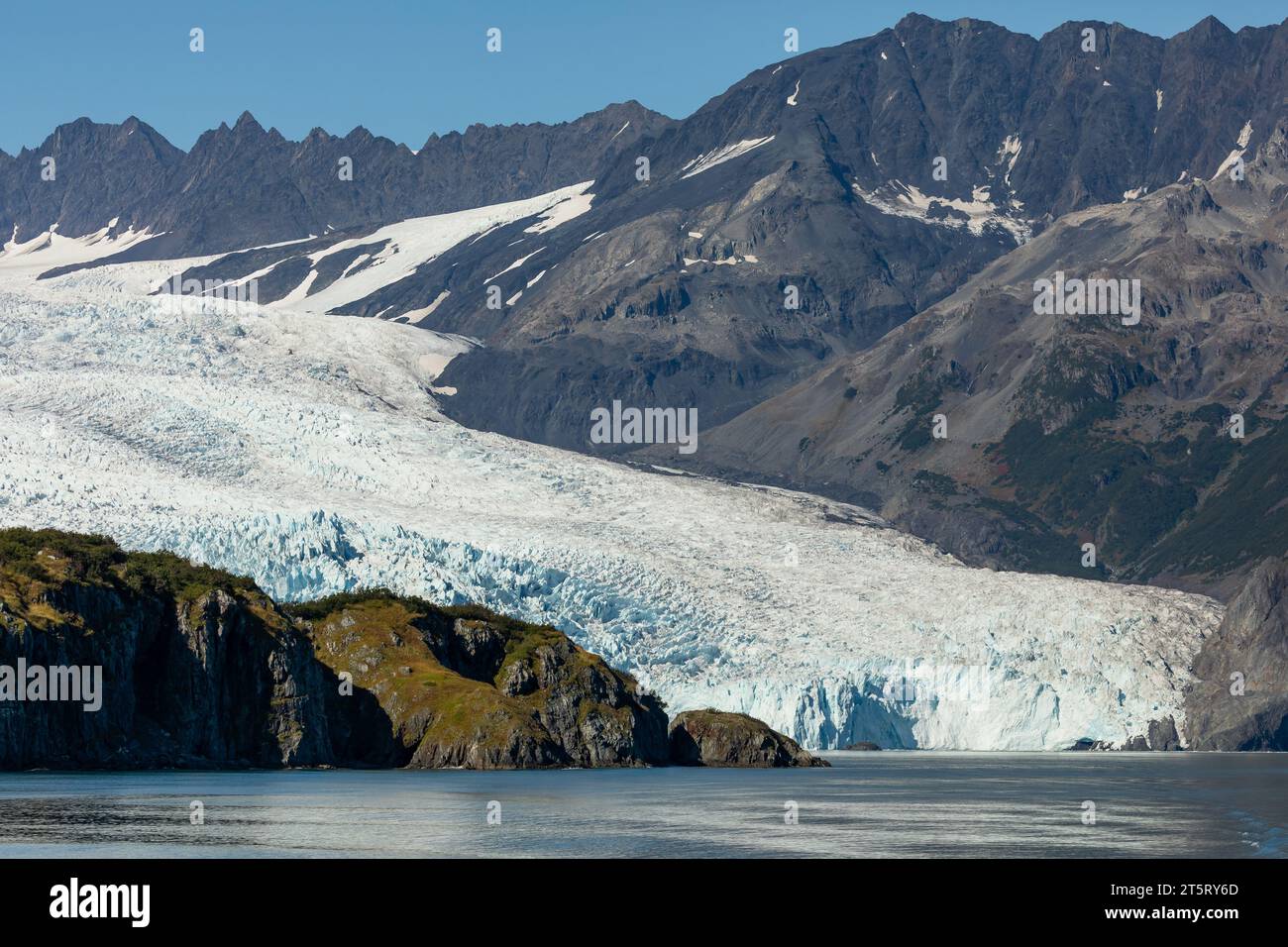 Blue ice of the Aialik Glacier meets the ocean waters of the Gulf of ...