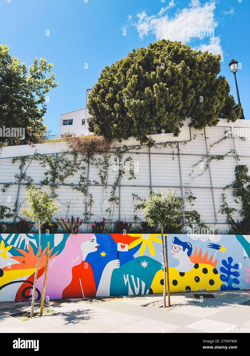 An urban scene with a graffiti mural painted on a wall in the ...