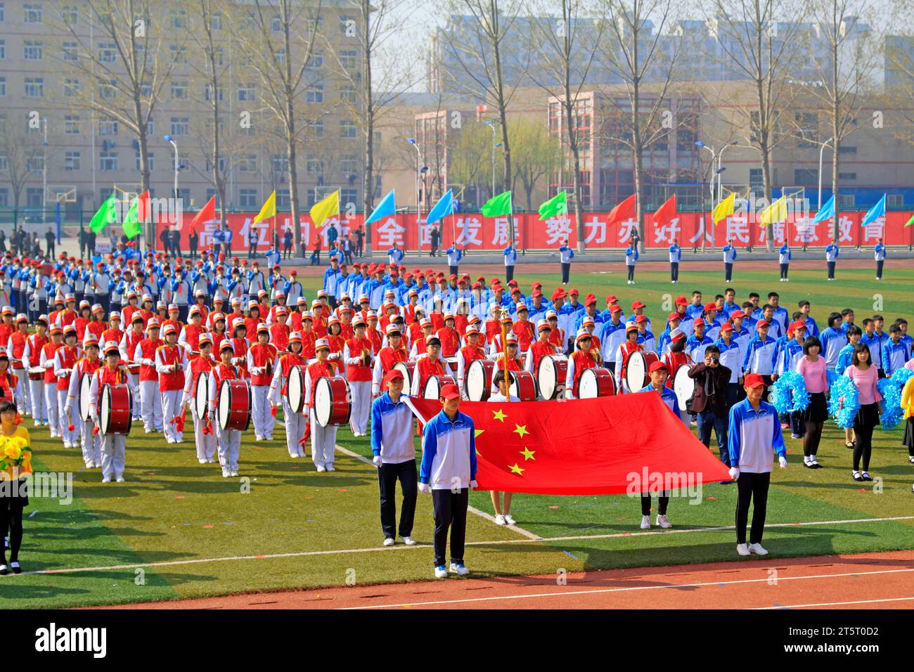 LUANNAN COUNTY - APRIL 14: China flag and flag bearer at the athletics ...