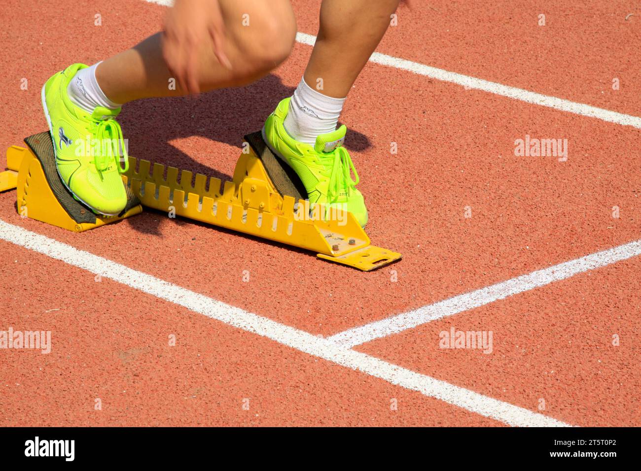 Starting blocks and the athlete's leg, closeup of photo Stock Photo - Alamy