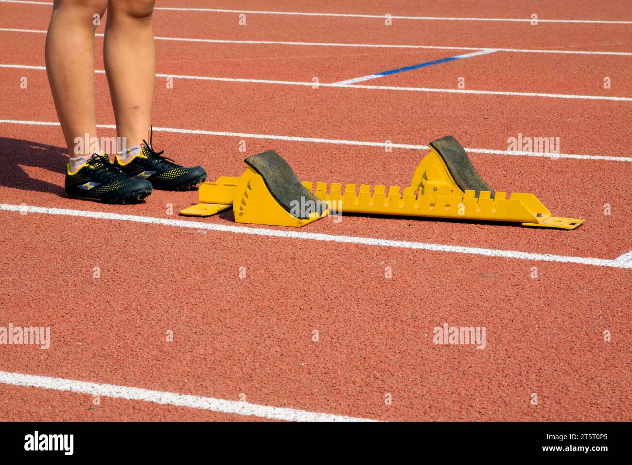 Starting blocks and the athlete's leg, closeup of photo Stock Photo - Alamy