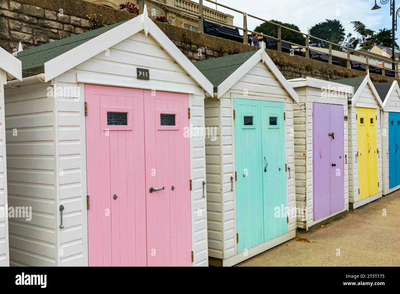 Lyme Regis Dorset, traditional English seafront beach huts painted in ...