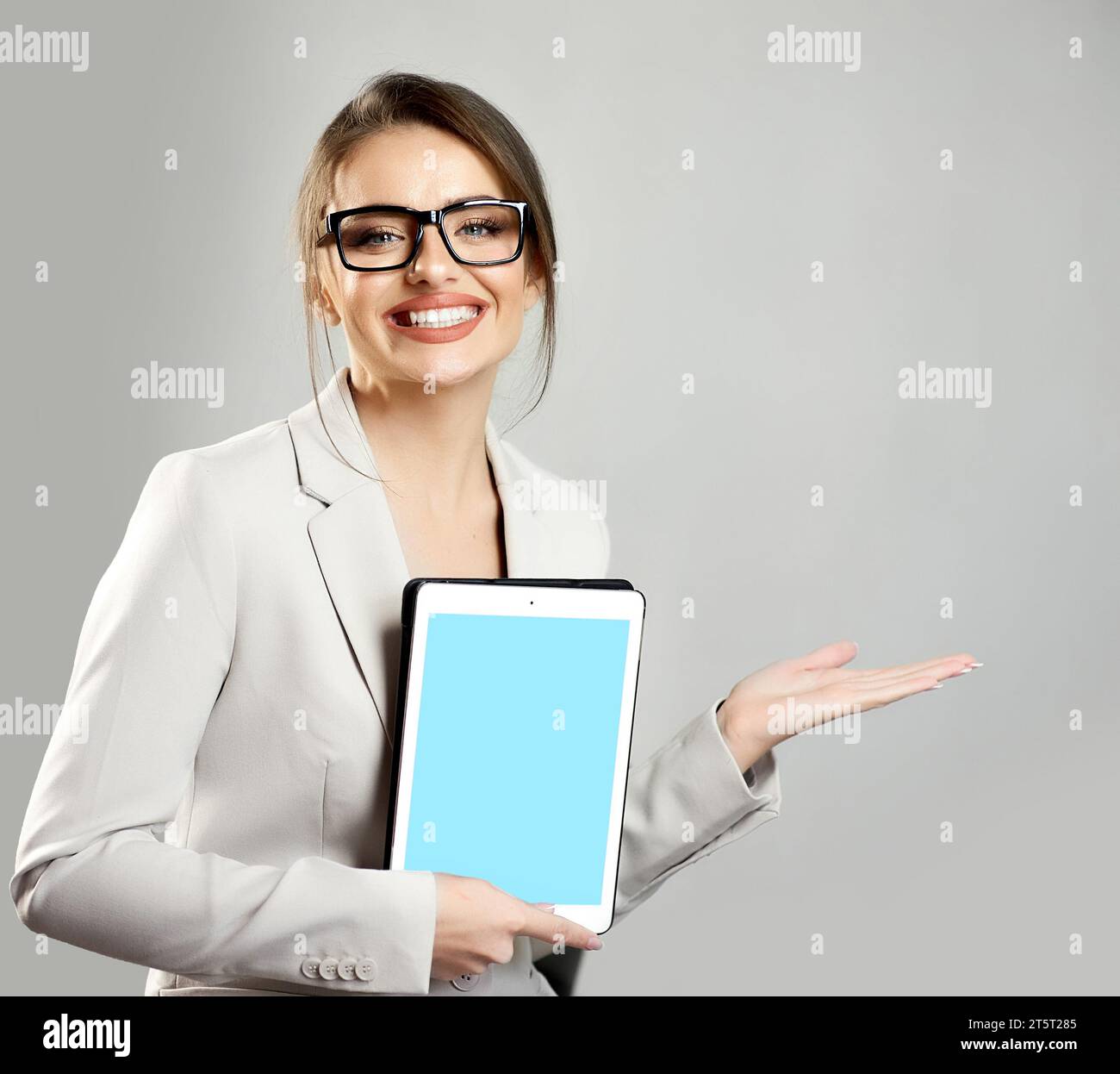 Smiling young woman holding palm open showing copy space for new ...