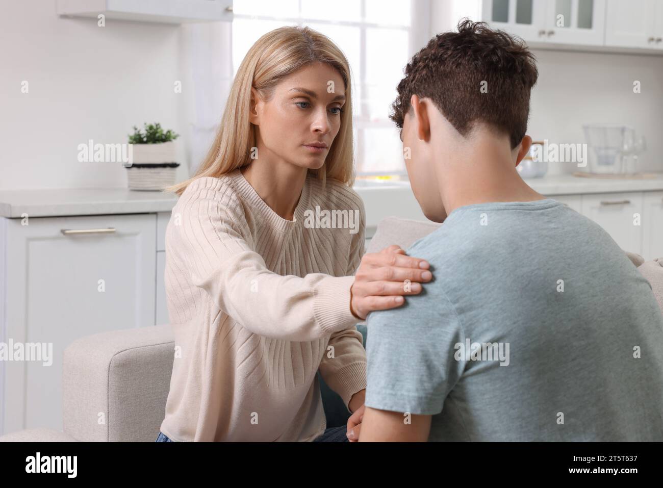 Mother consoling her upset son at home. Teenager problems Stock Photo ...