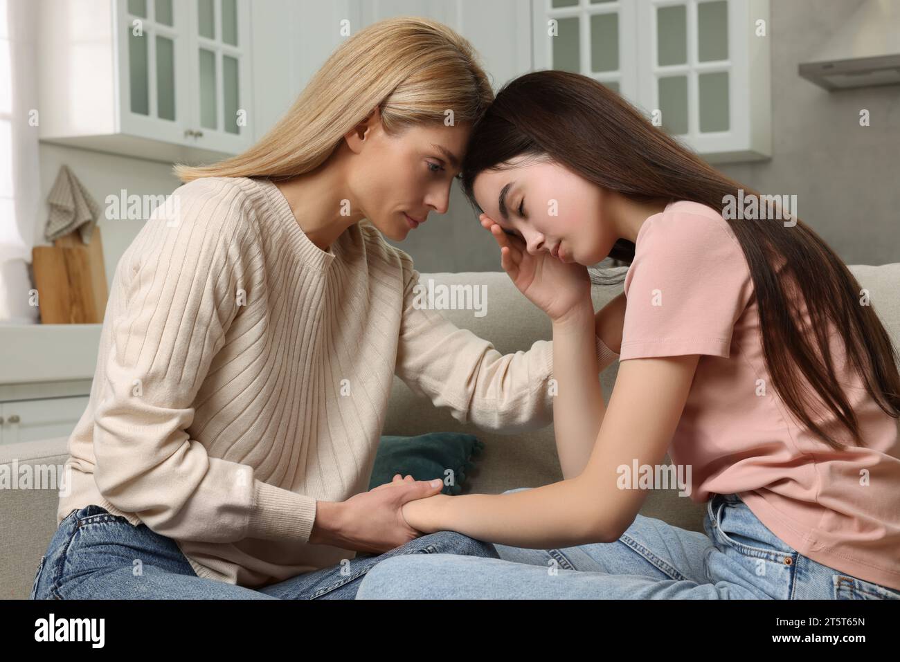 Mother consoling her upset daughter at home. Teenager problems Stock ...