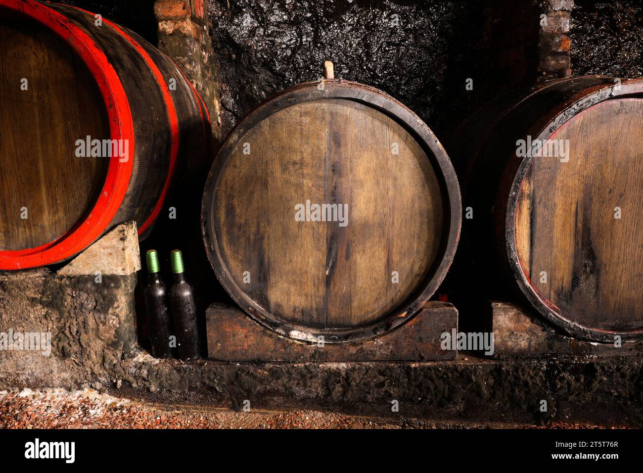 Wooden barrels with alcohol drinks in cellar Stock Photo - Alamy