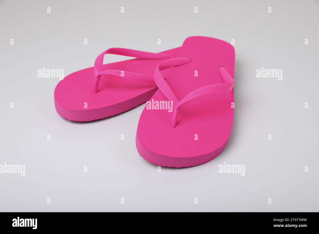 Stylish pink flip flops on white background Stock Photo - Alamy
