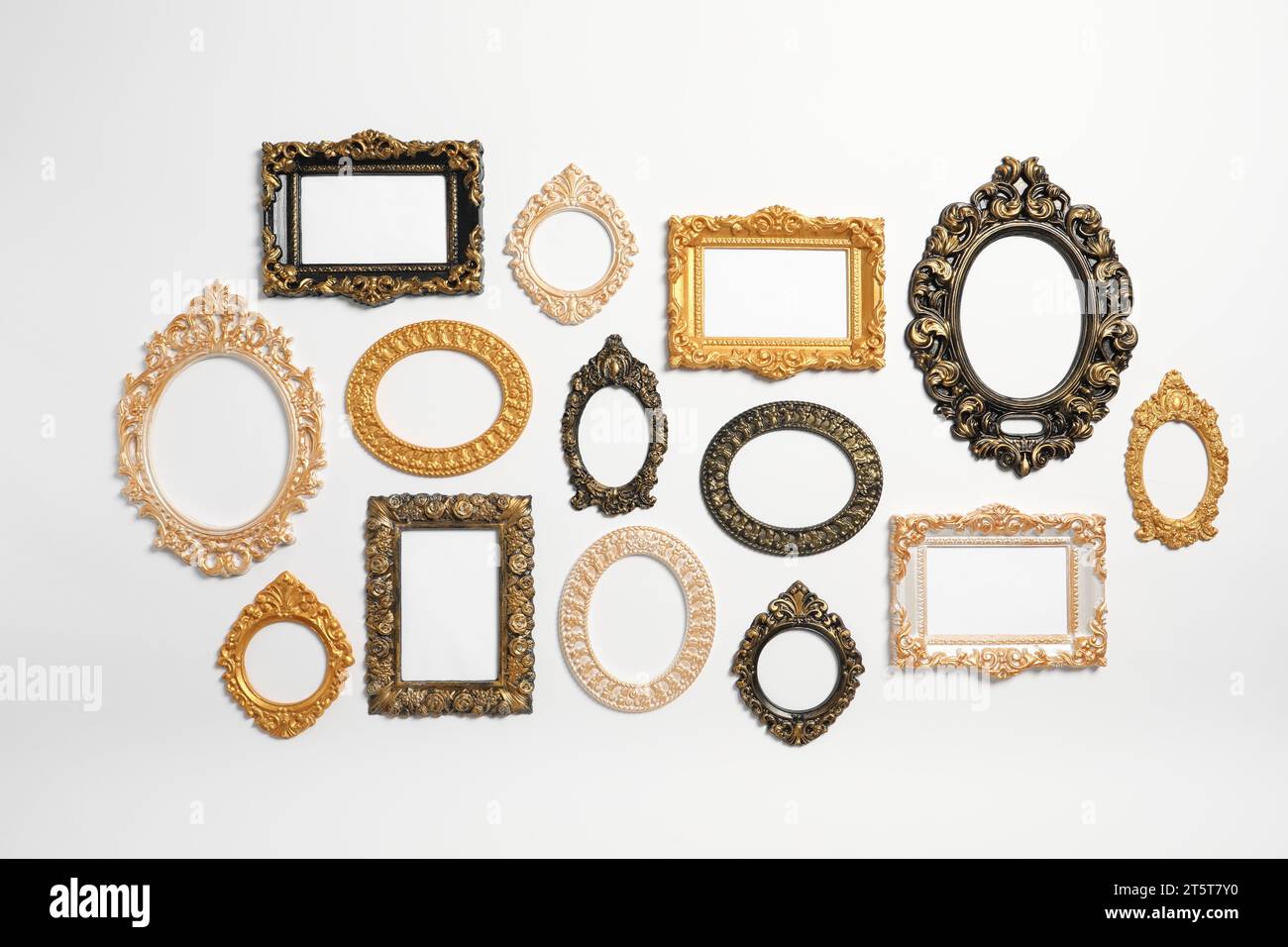 Empty vintage frames hanging on white wall Stock Photo - Alamy