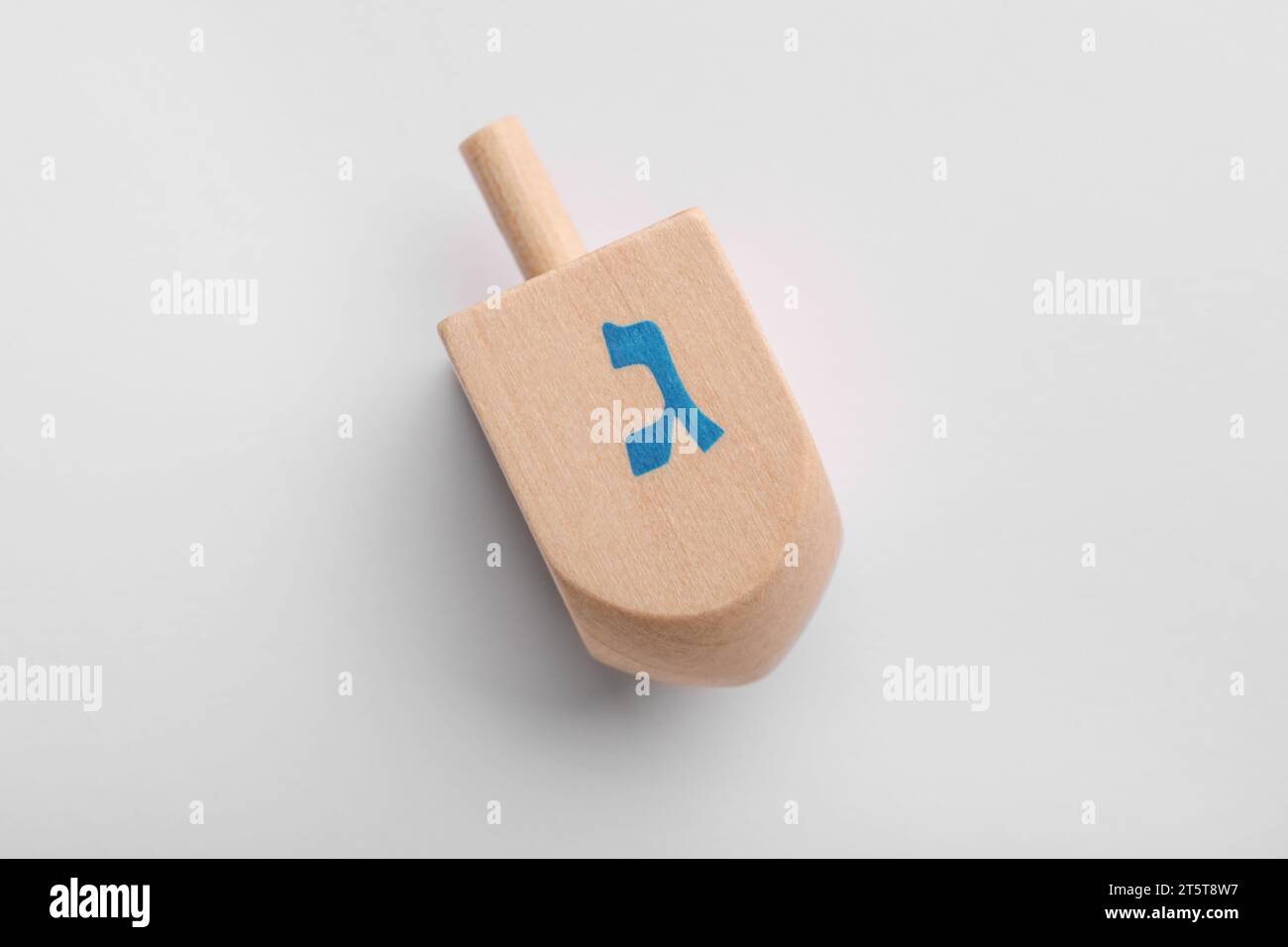 Wooden dreidel on white background, top view. Traditional Hanukkah game ...