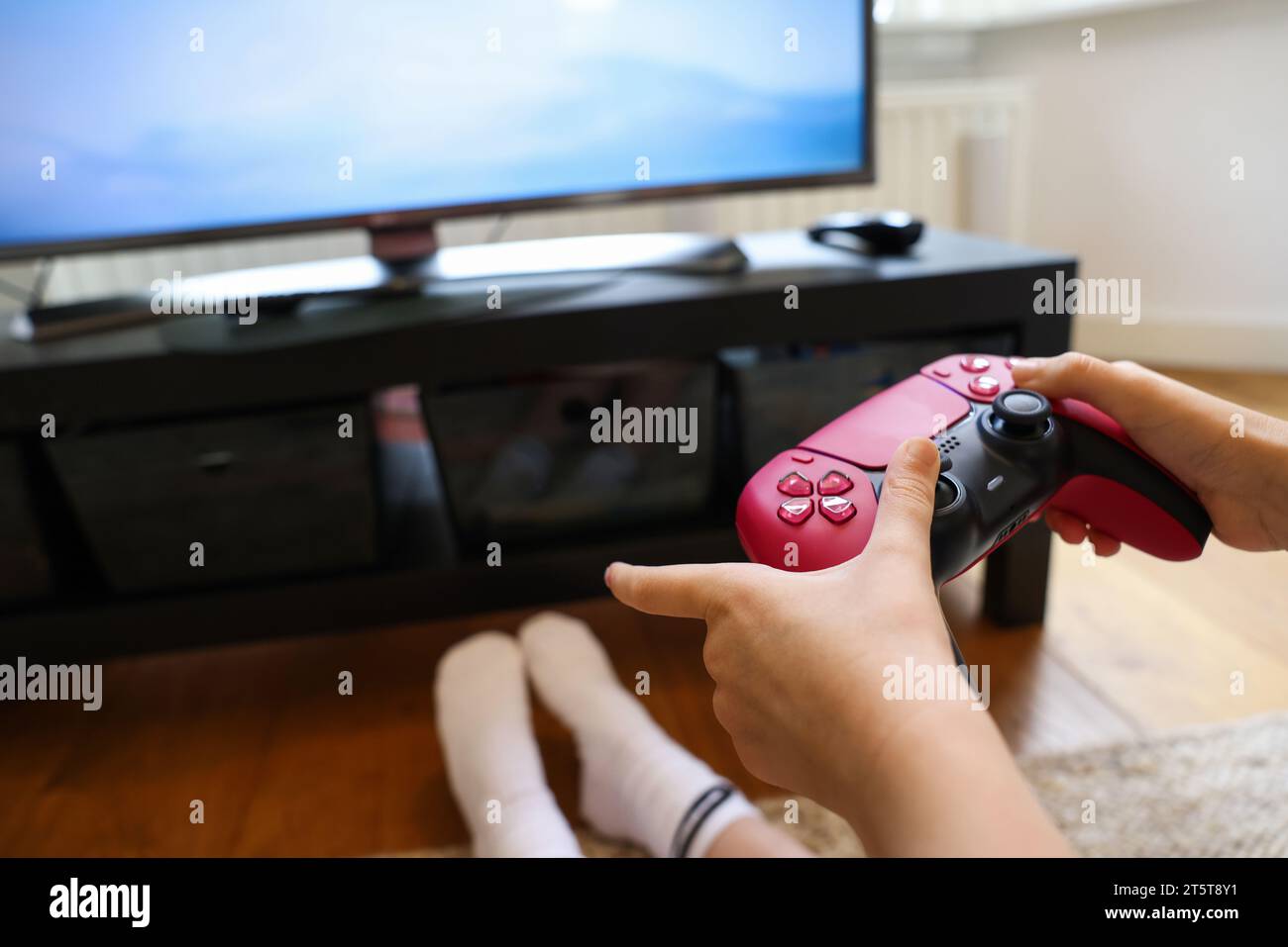 Child playing video games with controller at home, closeup Stock Photo ...